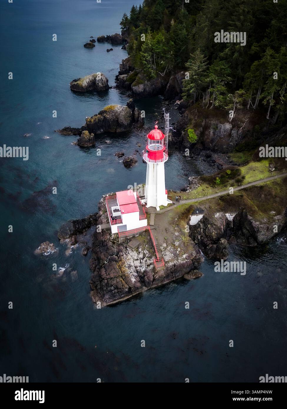Aerial view of rocky shore with lighthouse overlooking the ocean, Sooke ...