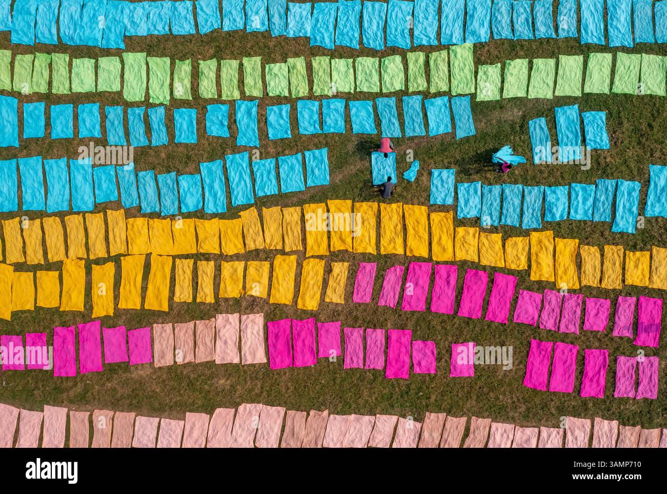 Aerial view of vibrant fabrics dyeing process with colorful patterns in ...