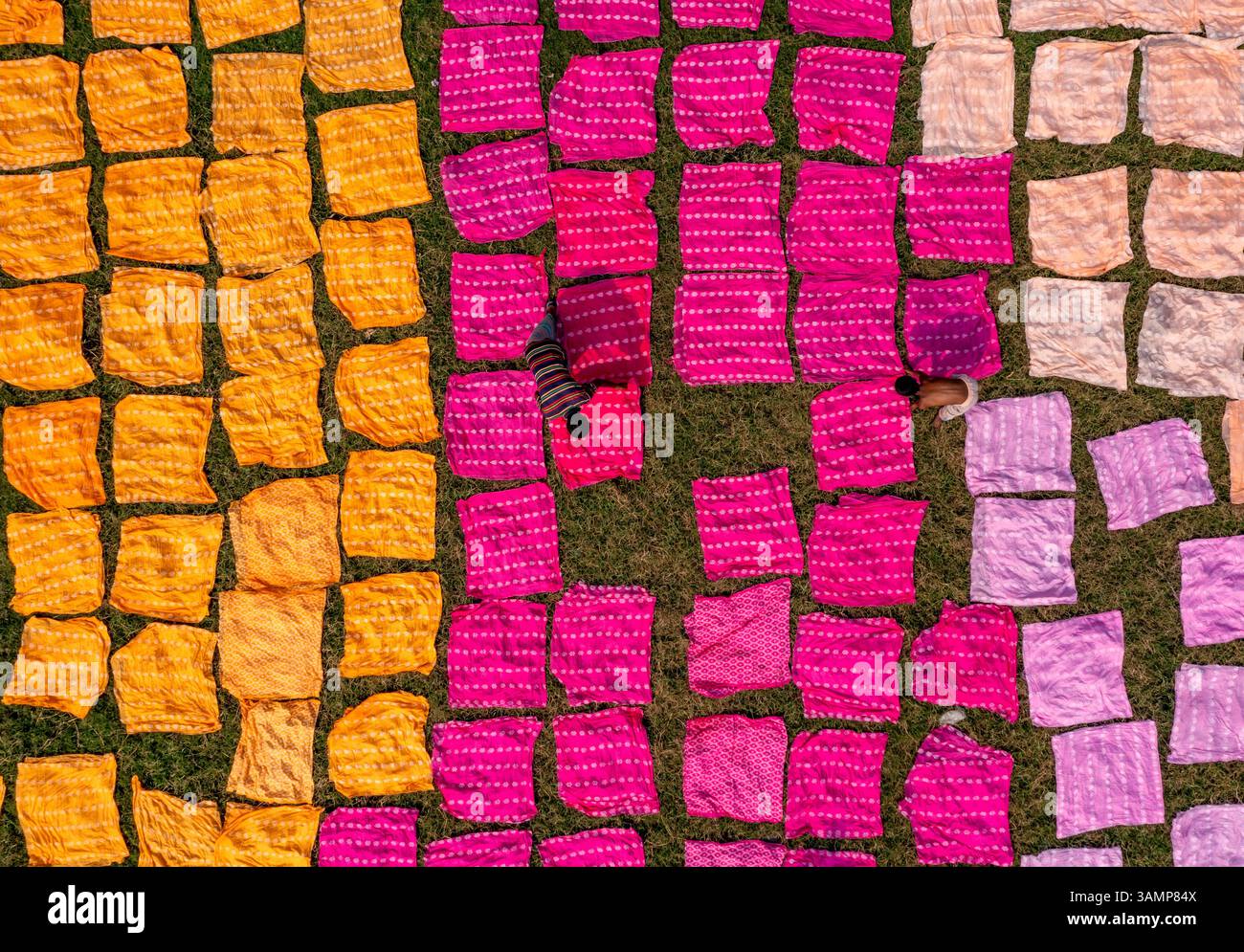 Aerial view of colorful fabrics dyeing workshop with workers and patterns, Duptara, Araihazar ...