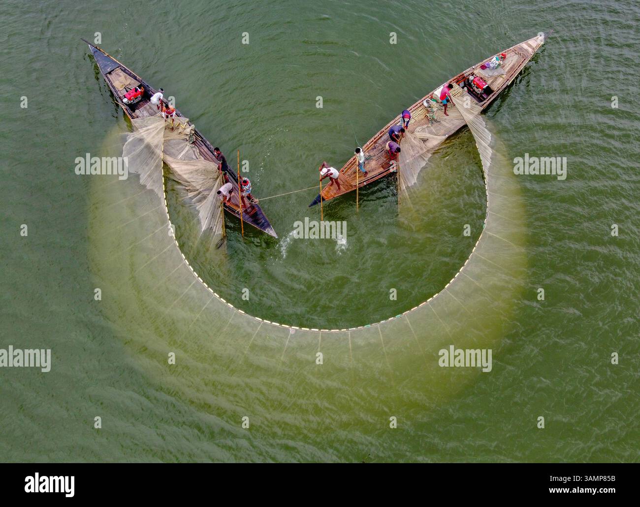 Aerial view of fishing with huge net on a river with traditional boats ...
