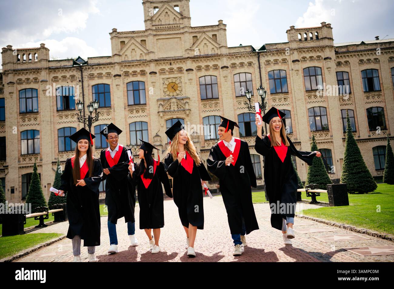 Full body portrait of group students laugh walk coblestone path ...
