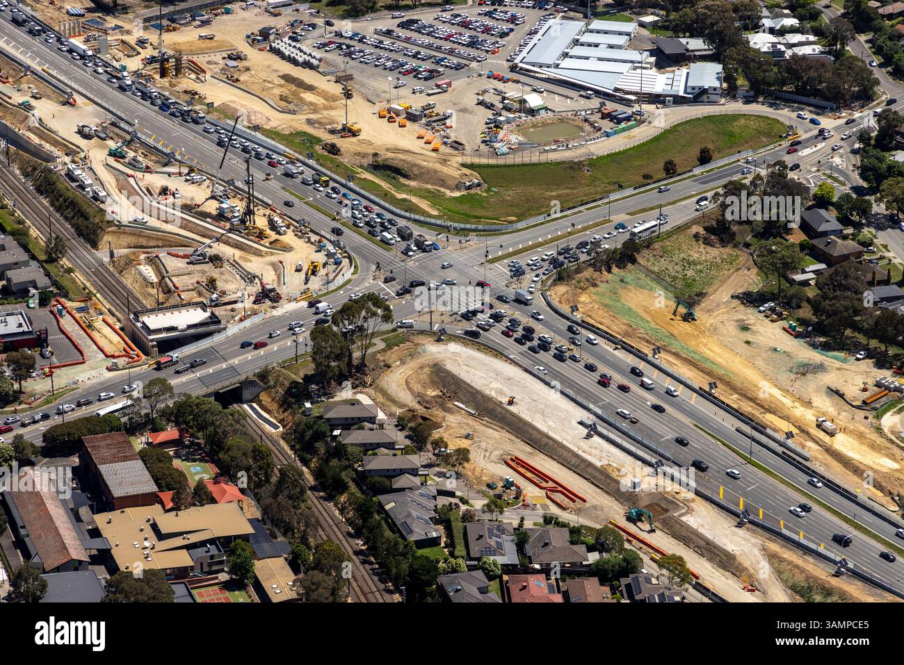 Aerial view of urban intersection with traffic and vehicles surrounded ...