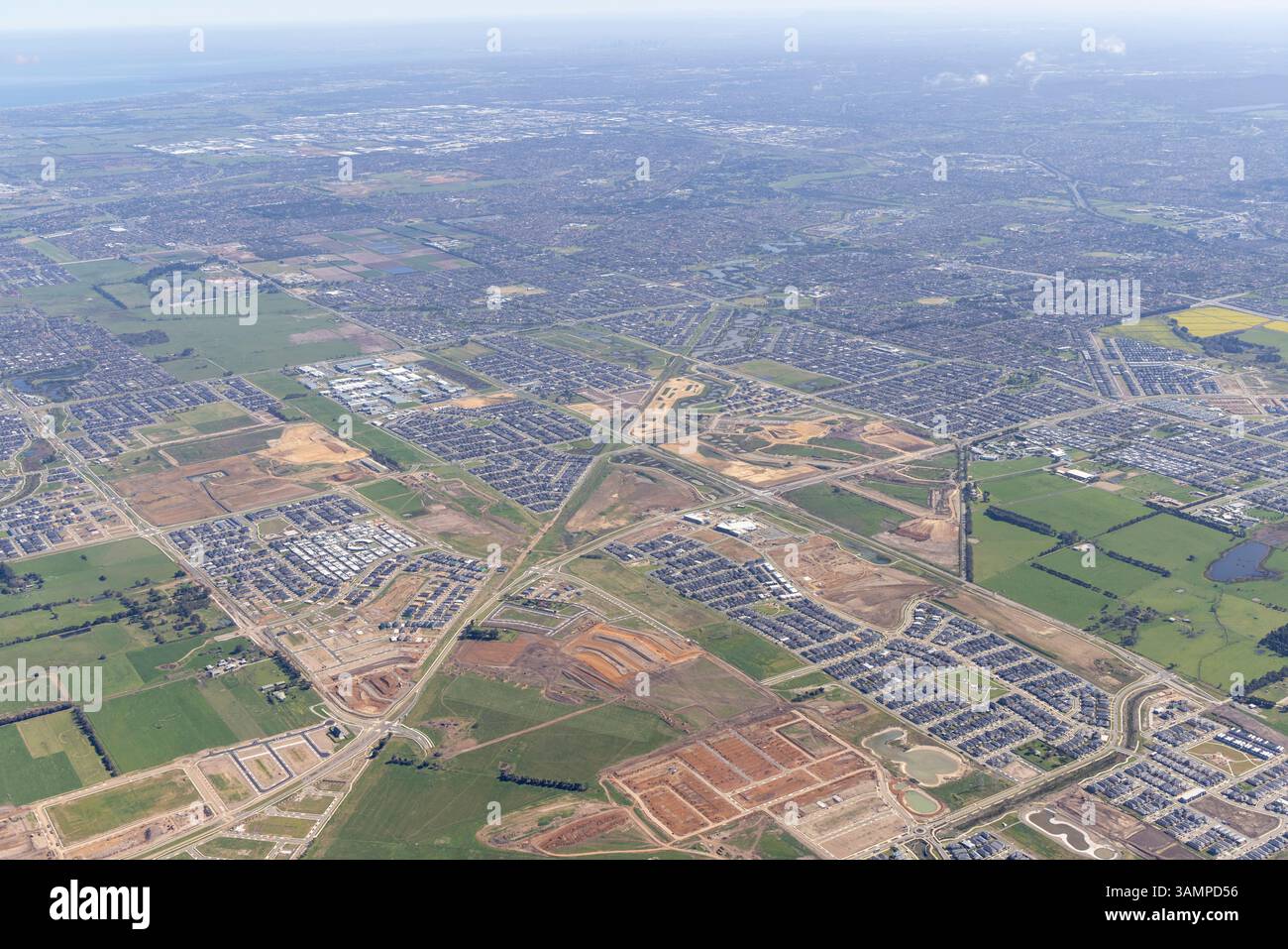 Aerial view of a beautiful residential area with fields and roads under ...
