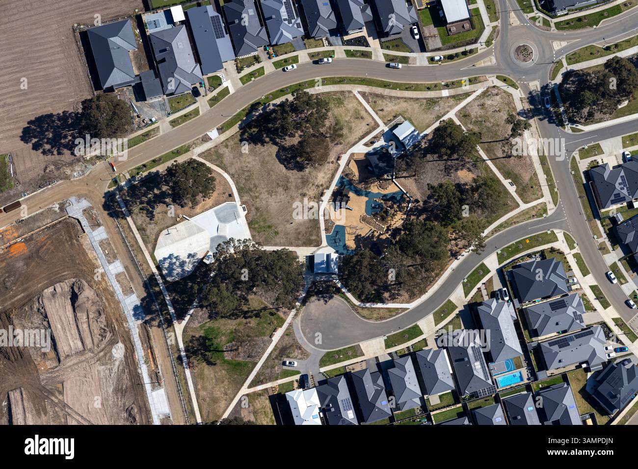 Aerial view of modern residential area with homes, park, and green ...