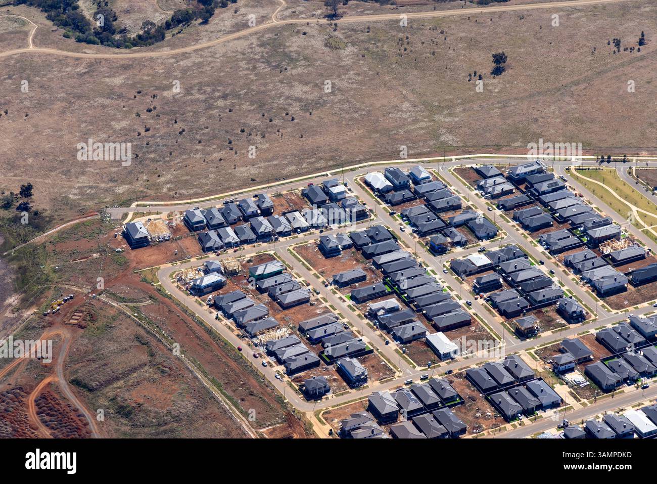 Aerial view of modern suburban housing development with roads and ...