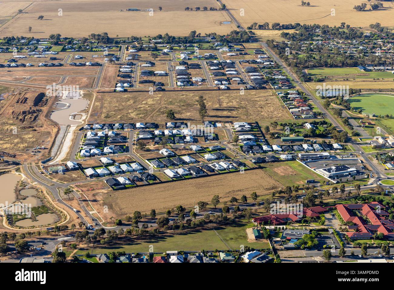 Aerial view of suburban residential district with homes and fields ...