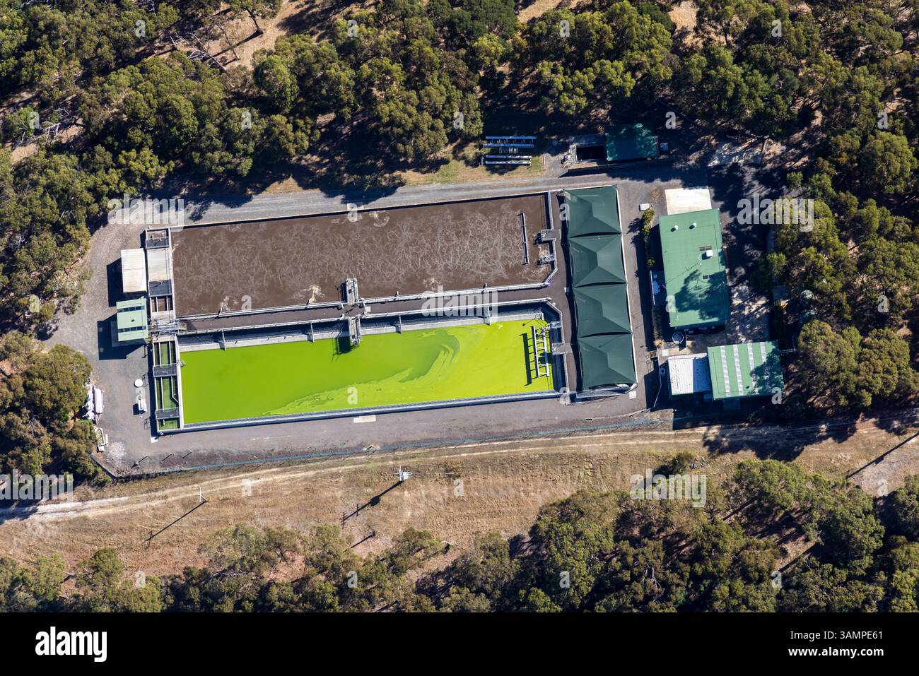Aerial view of an industrial water treatment facility with a green ...