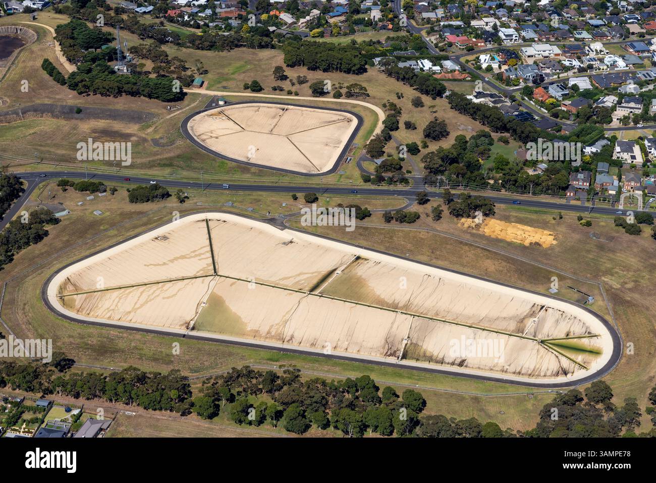 Aerial view of residential area with roads, fields, and greenery ...