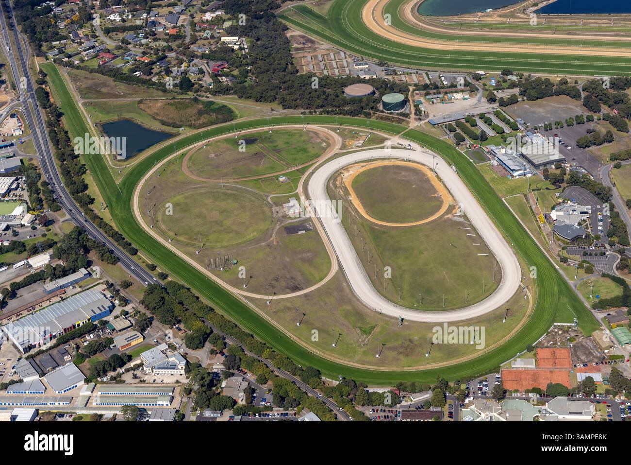 Aerial view of a beautiful horse race track surrounded by urban ...