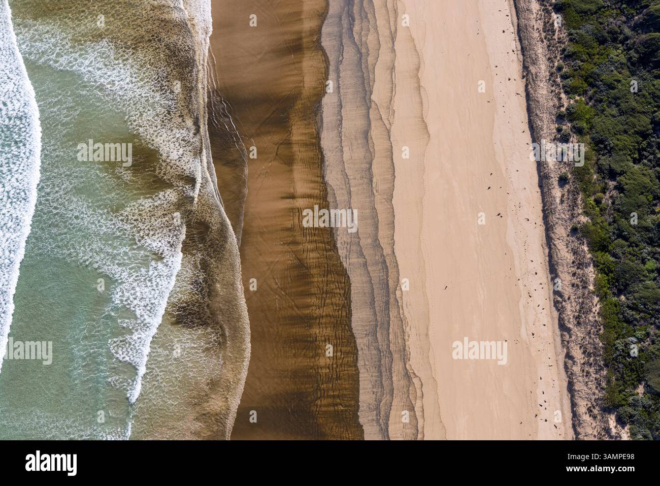 Aerial view of beautiful sandy beach and coastline with waves lapping ...