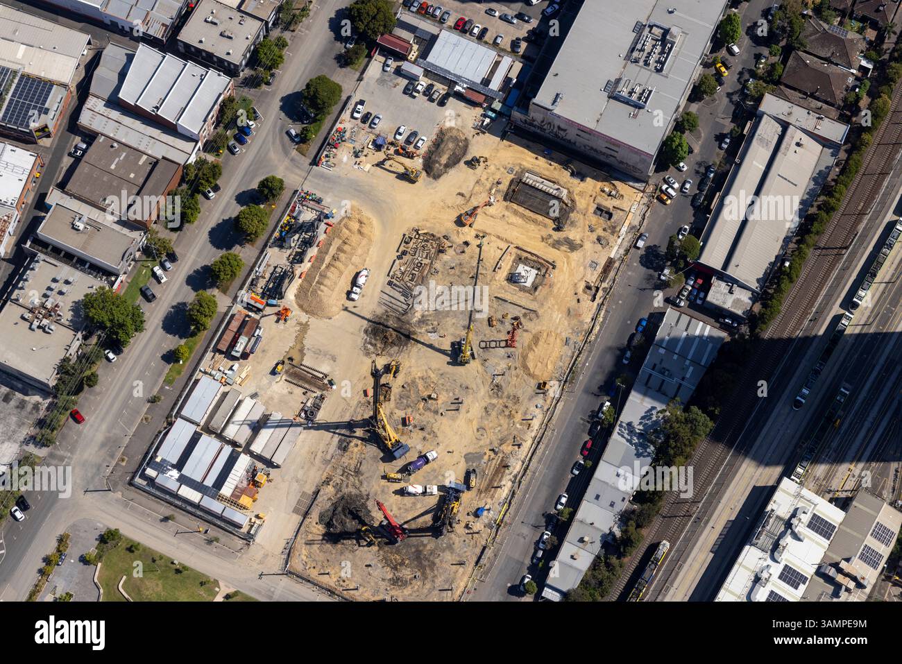 Aerial view of a bustling construction site with cranes and vehicles ...