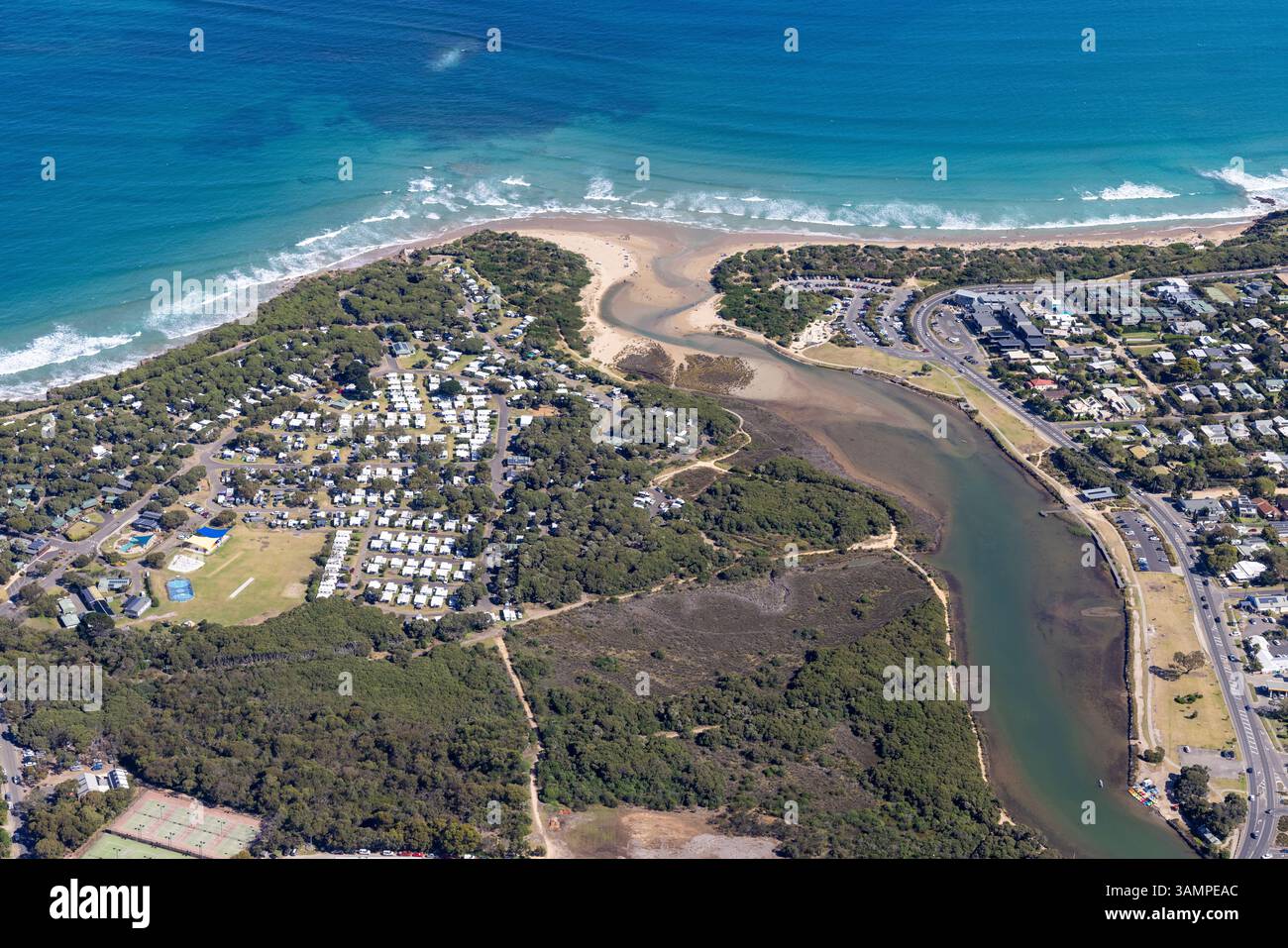 Aerial view of beautiful coastal town with beach and forest near the ...