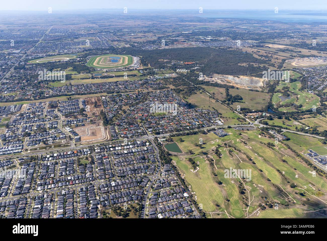 Aerial view of suburban housing and green spaces with winding roads and ...