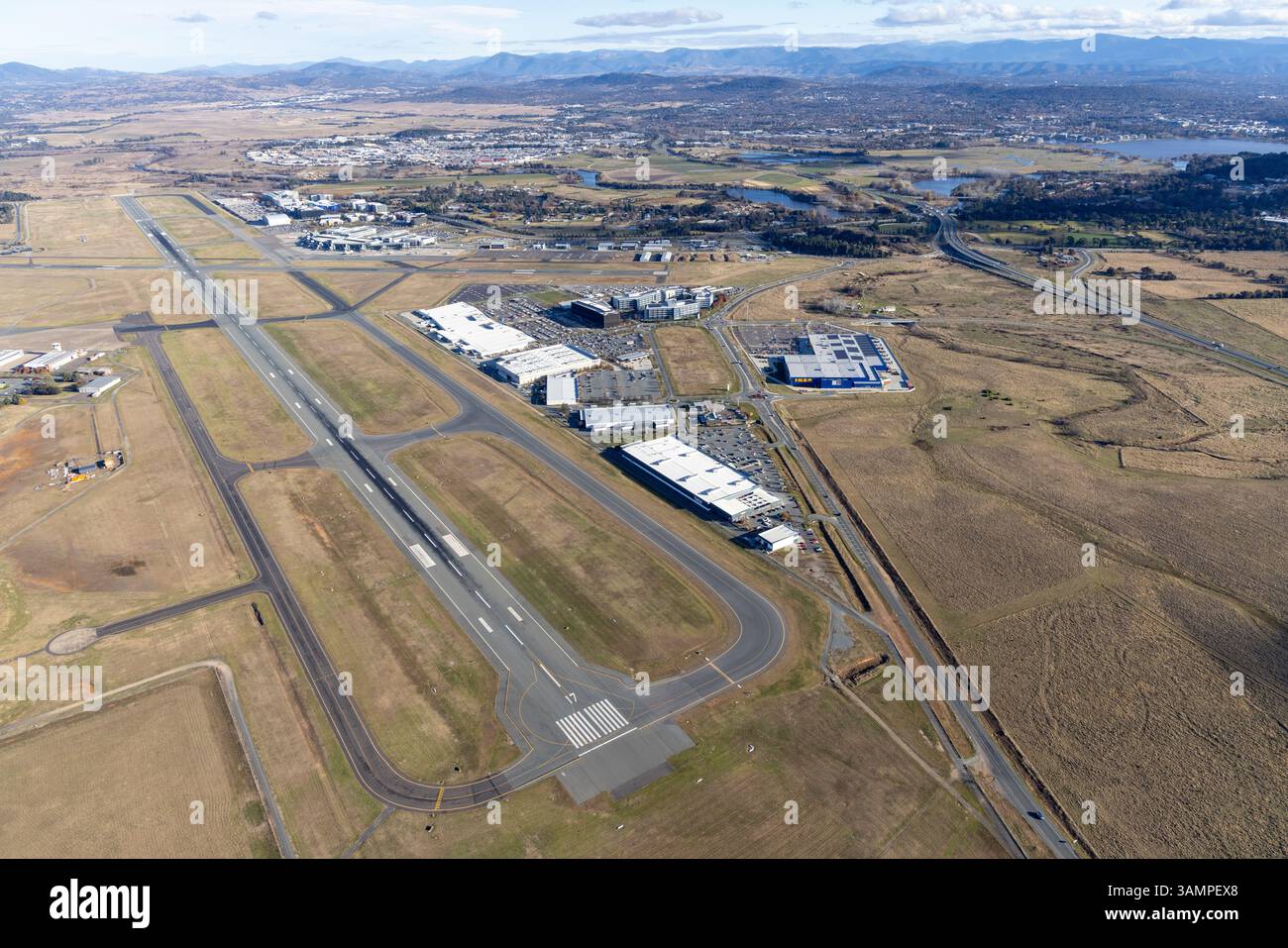 Aerial view of canberra airport with runway, buildings, fields, and ...