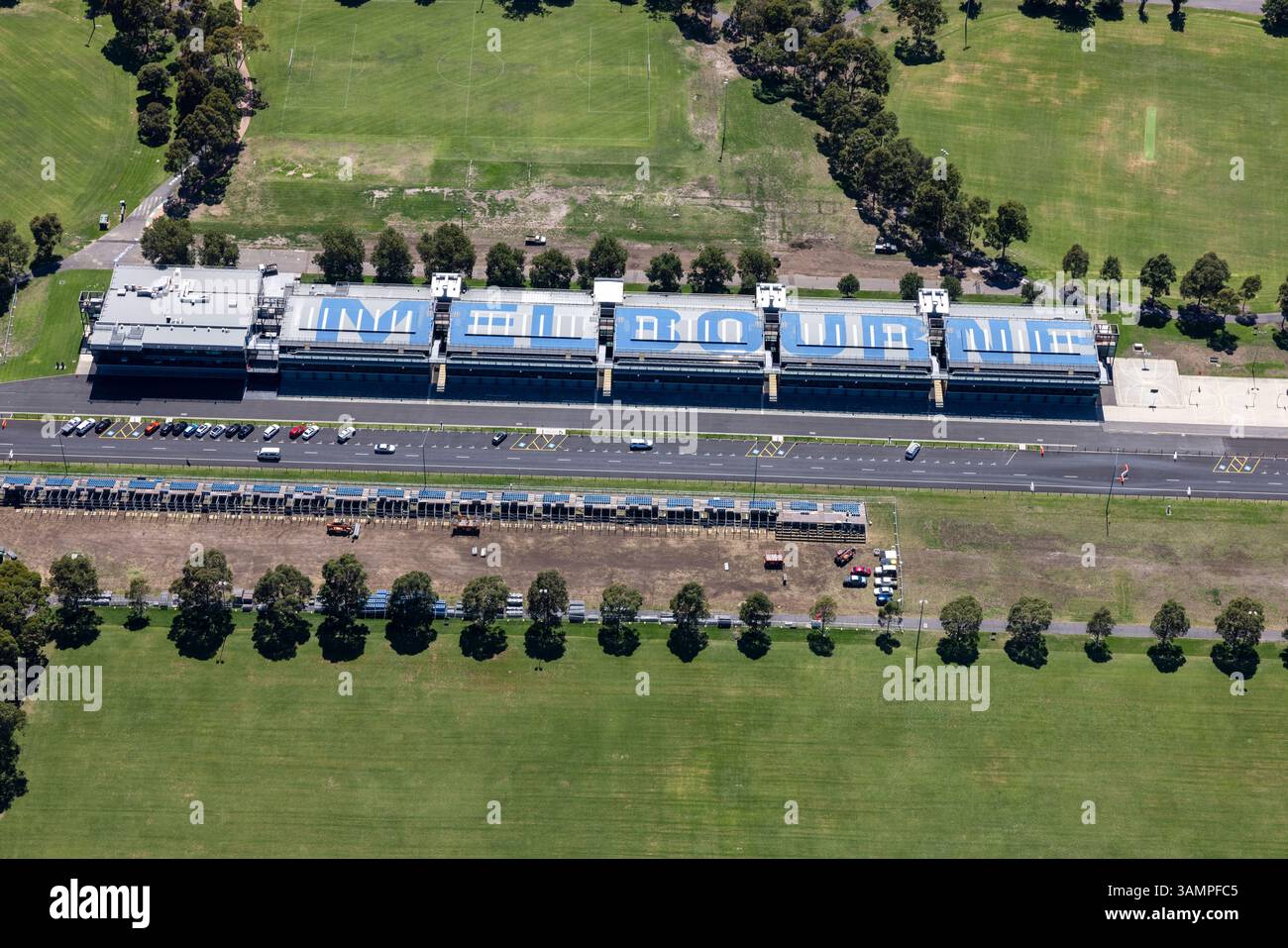 Aerial view of Albert Park with race track, buildings, cars, and trees ...