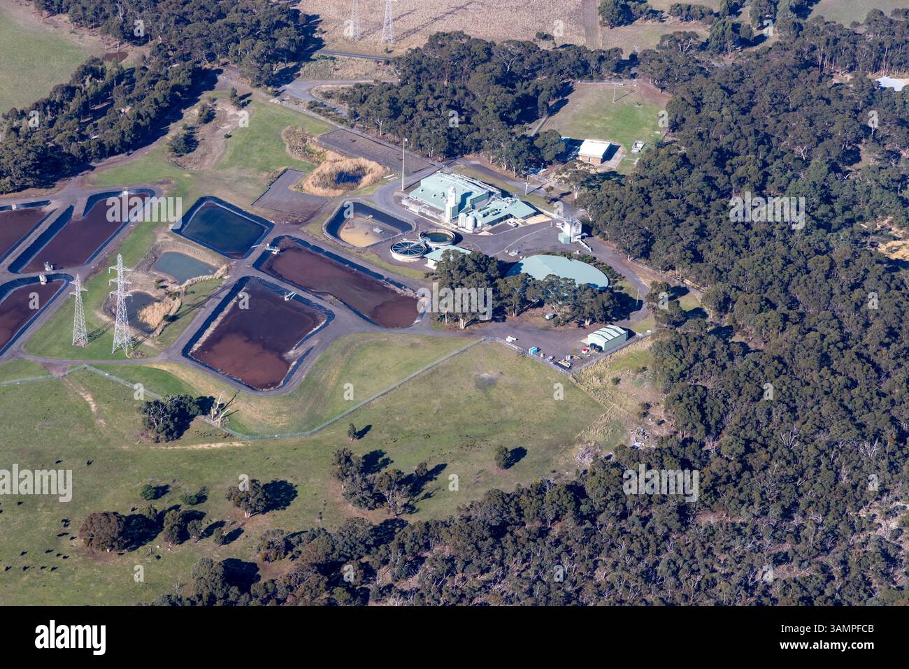 Aerial view of water treatment plant surrounded by greenery and forest ...