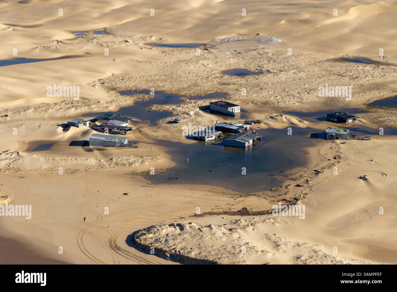 Aerial view of beautiful sand dunes and barren landscape with scattered ...