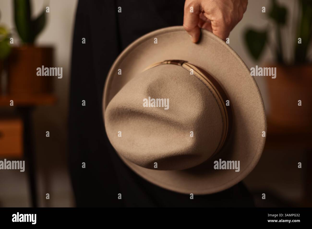 Close up of a caucasians mans hand holding a beautiful brown felt ...