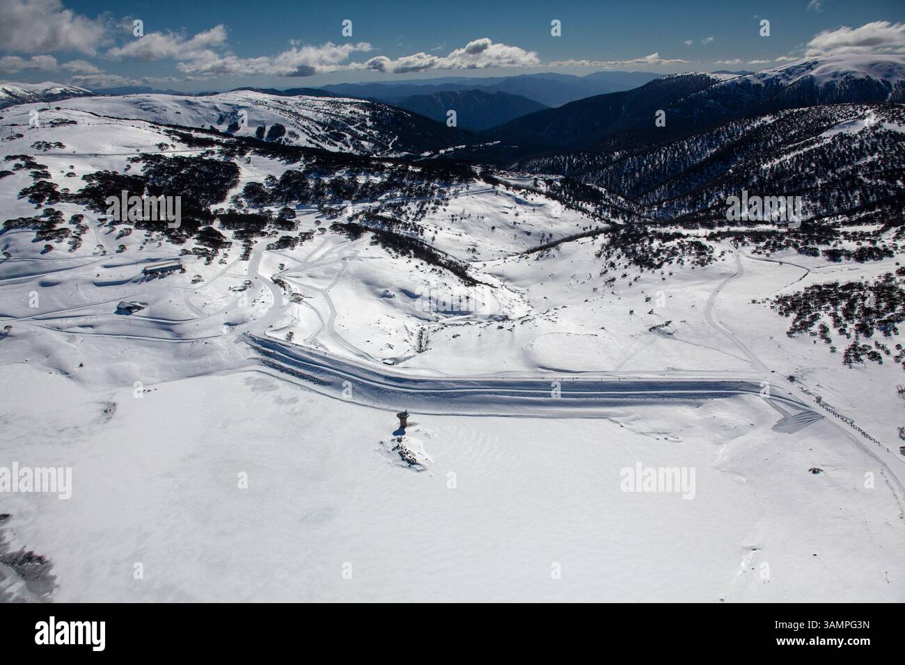 Aerial view of Mount Hotham ski resort with people skiing in a snowy landscape, Victoria ...