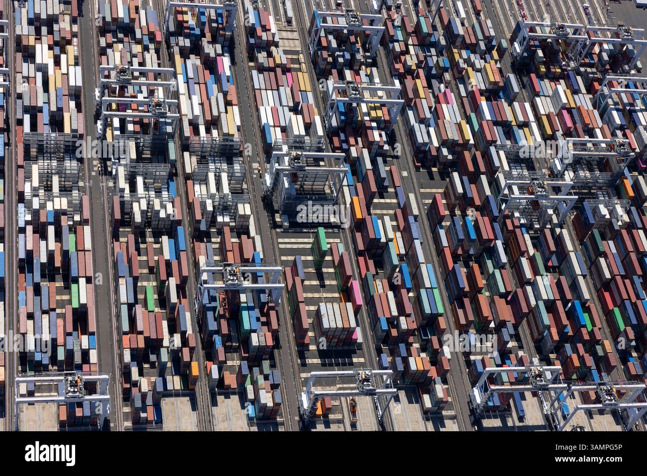 Aerial view of container harbour with stacked containers and cranes ...