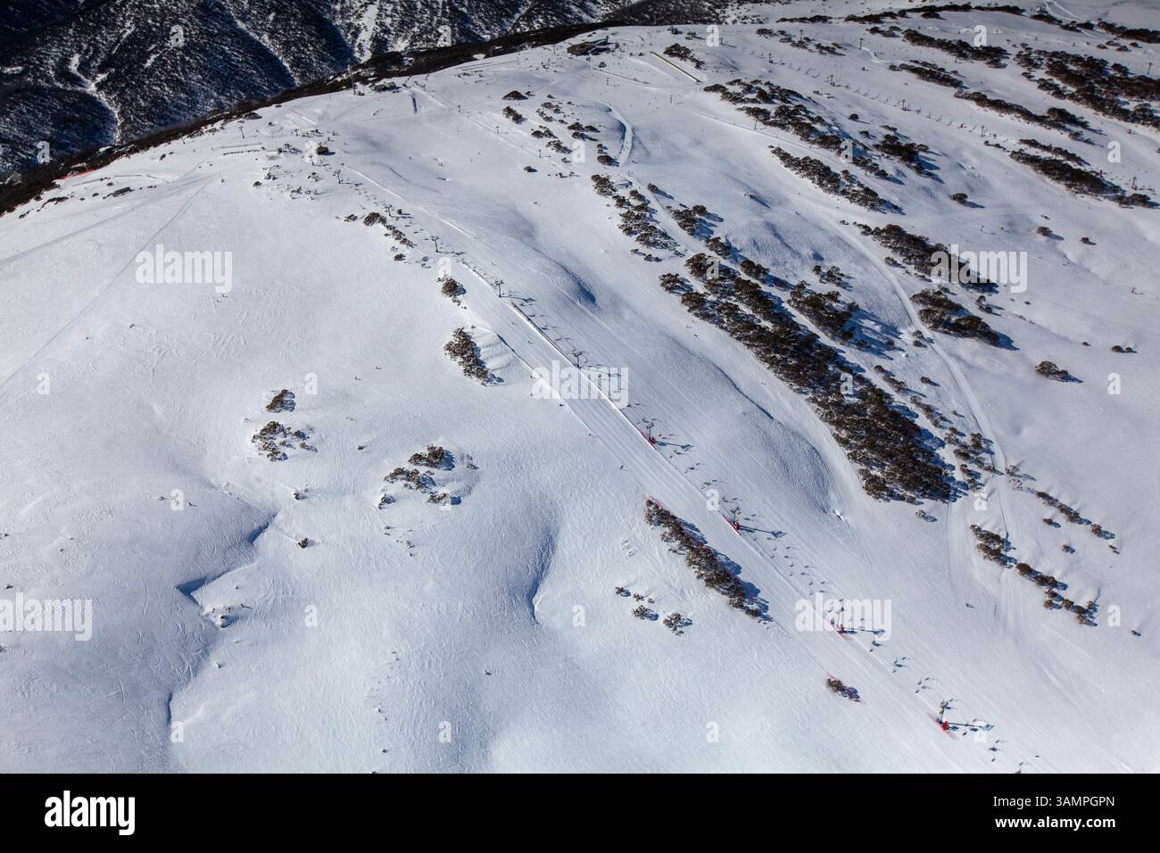 Aerial view of people skiing at a beautiful ski resort in snowy Mount ...