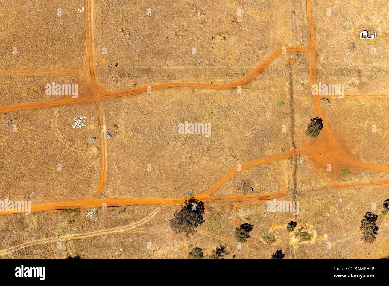 Aerial view of dry track field with dirt road and trees, Brookfield ...