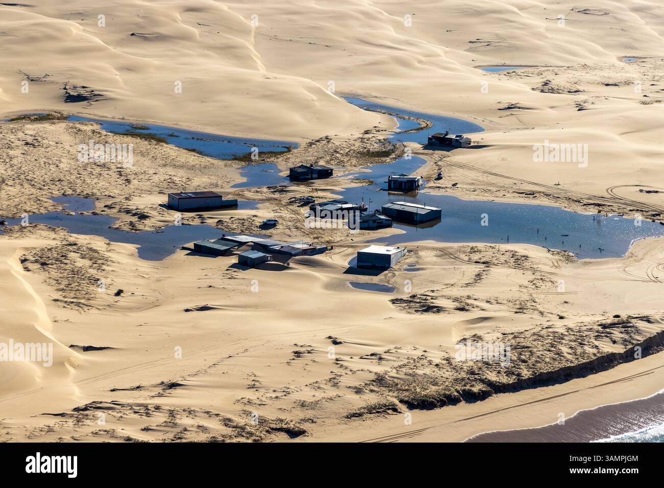 Aerial view of beached houses with flood on Stockton Beach, Worimi ...