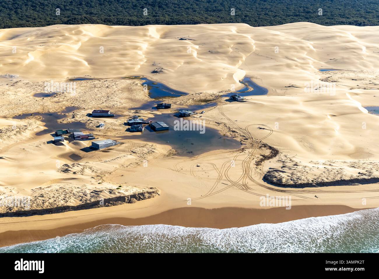 Aerial view of beached houses with flood on Stockton Beach, Worimi ...