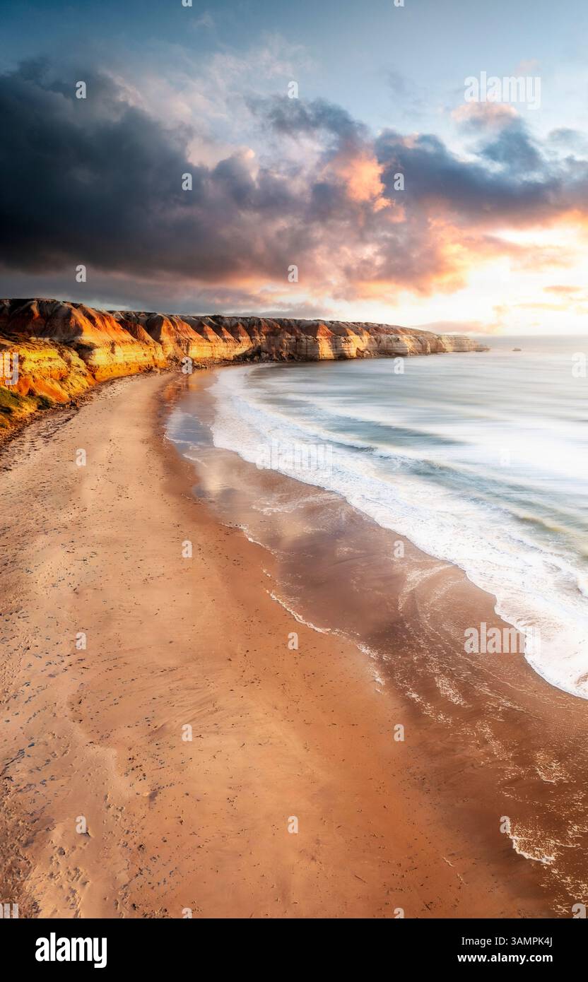Aerial view of peaceful Maslin Beach with cliffs and clouds at sunset ...