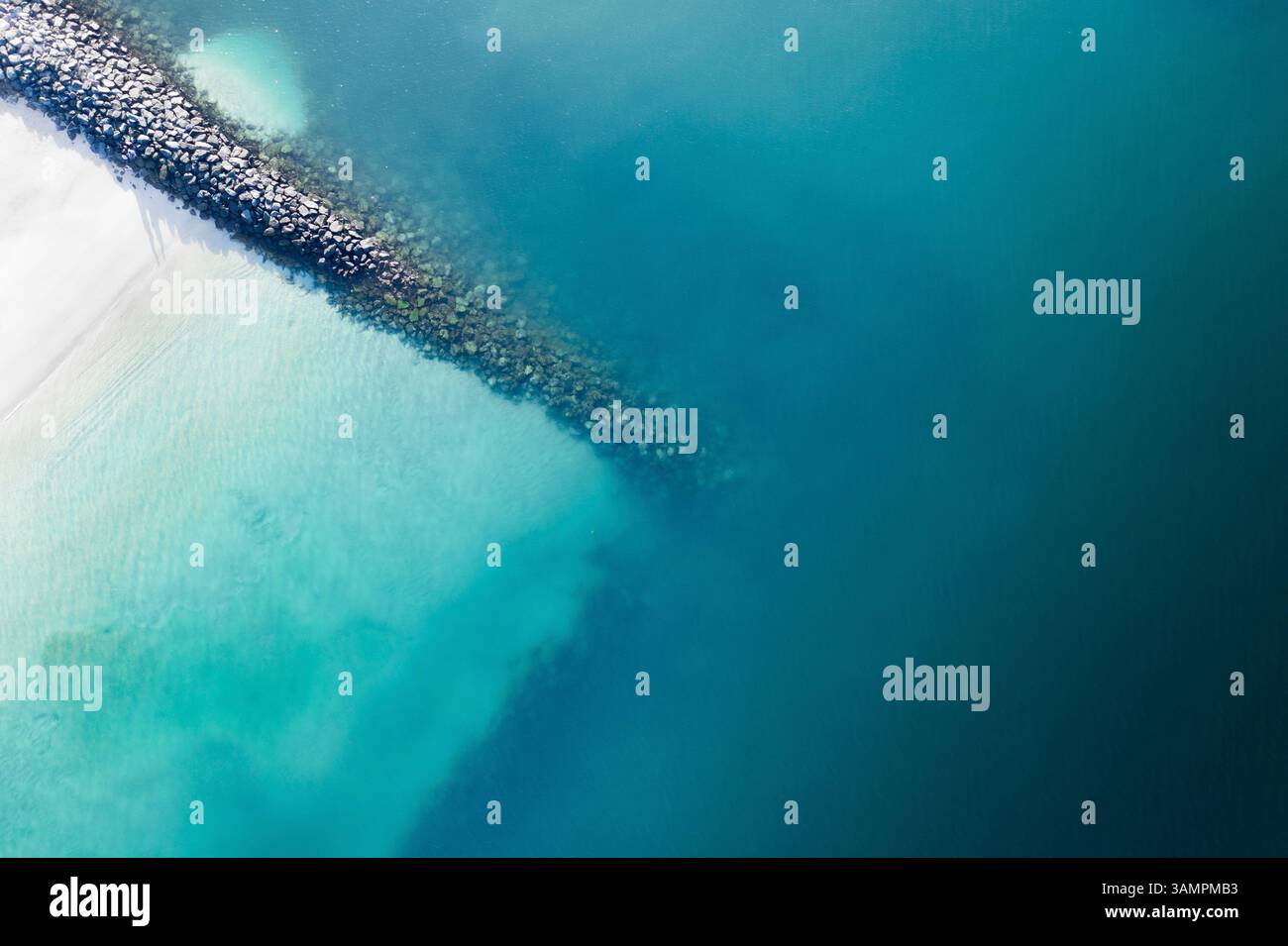 Aerial view of serene beach with crystal clear ocean and coastal ...