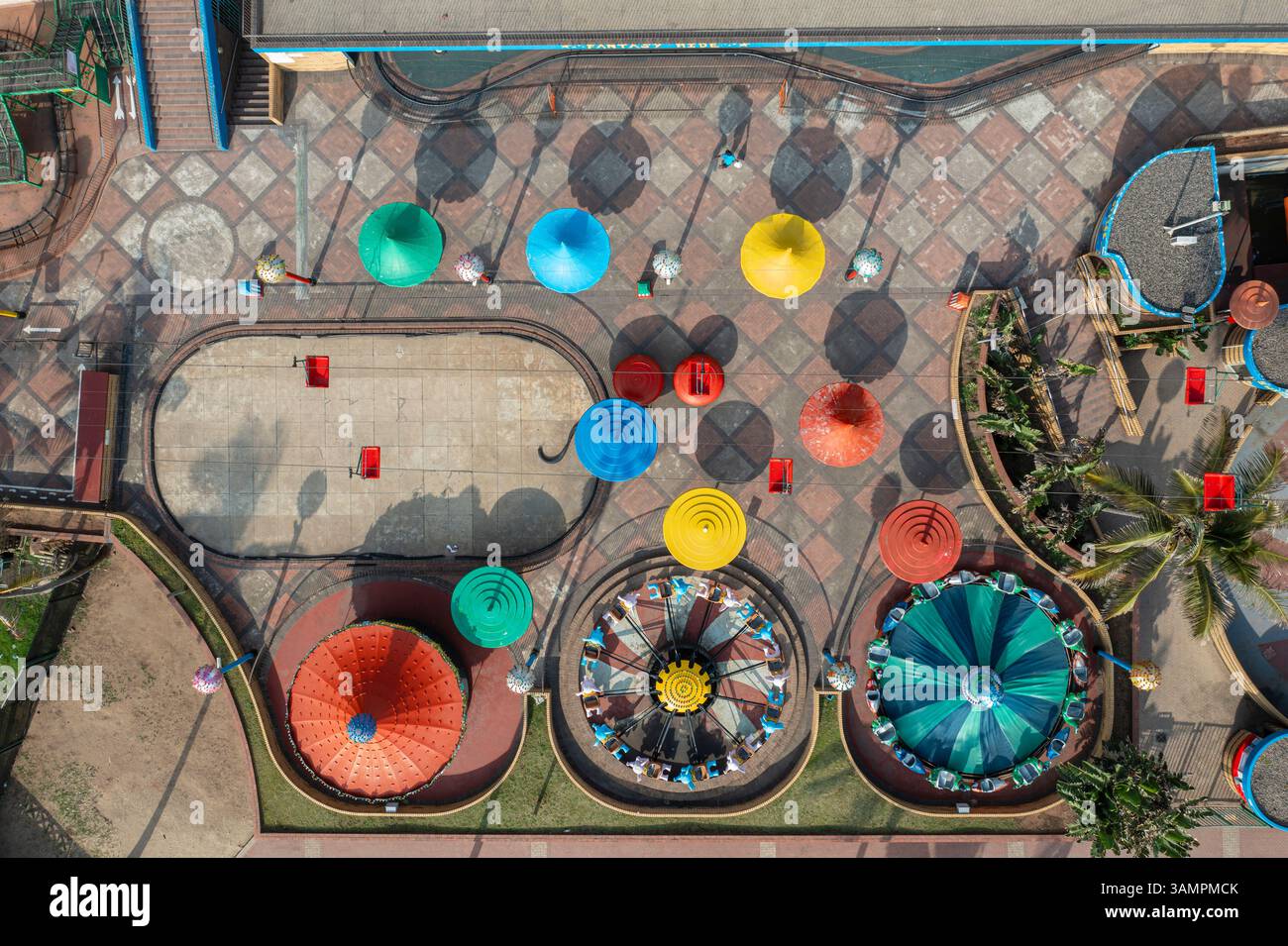 Aerial view of colorful umbrellas and shadows at amusement park, Durban ...
