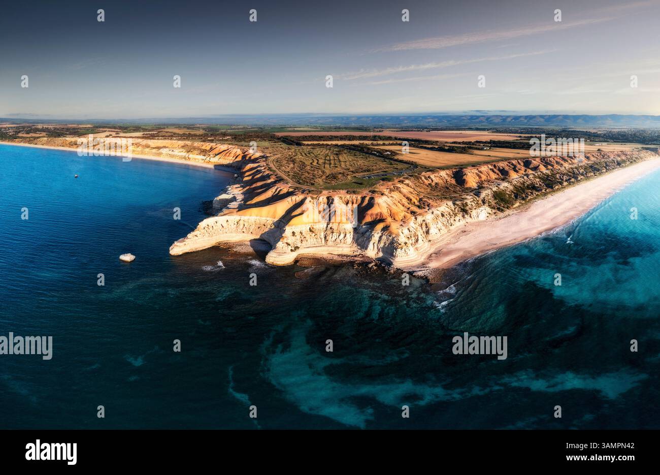 Aerial view of rugged limestone cliffs with a turquoise blue ocean in ...