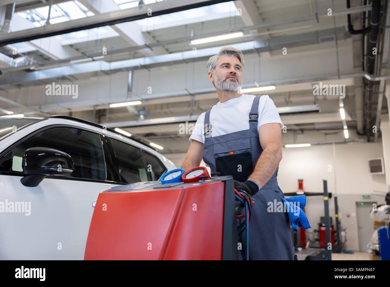 Bearded man technician checking car air conditioning system refrigerant recharge Stock Photo - Alamy