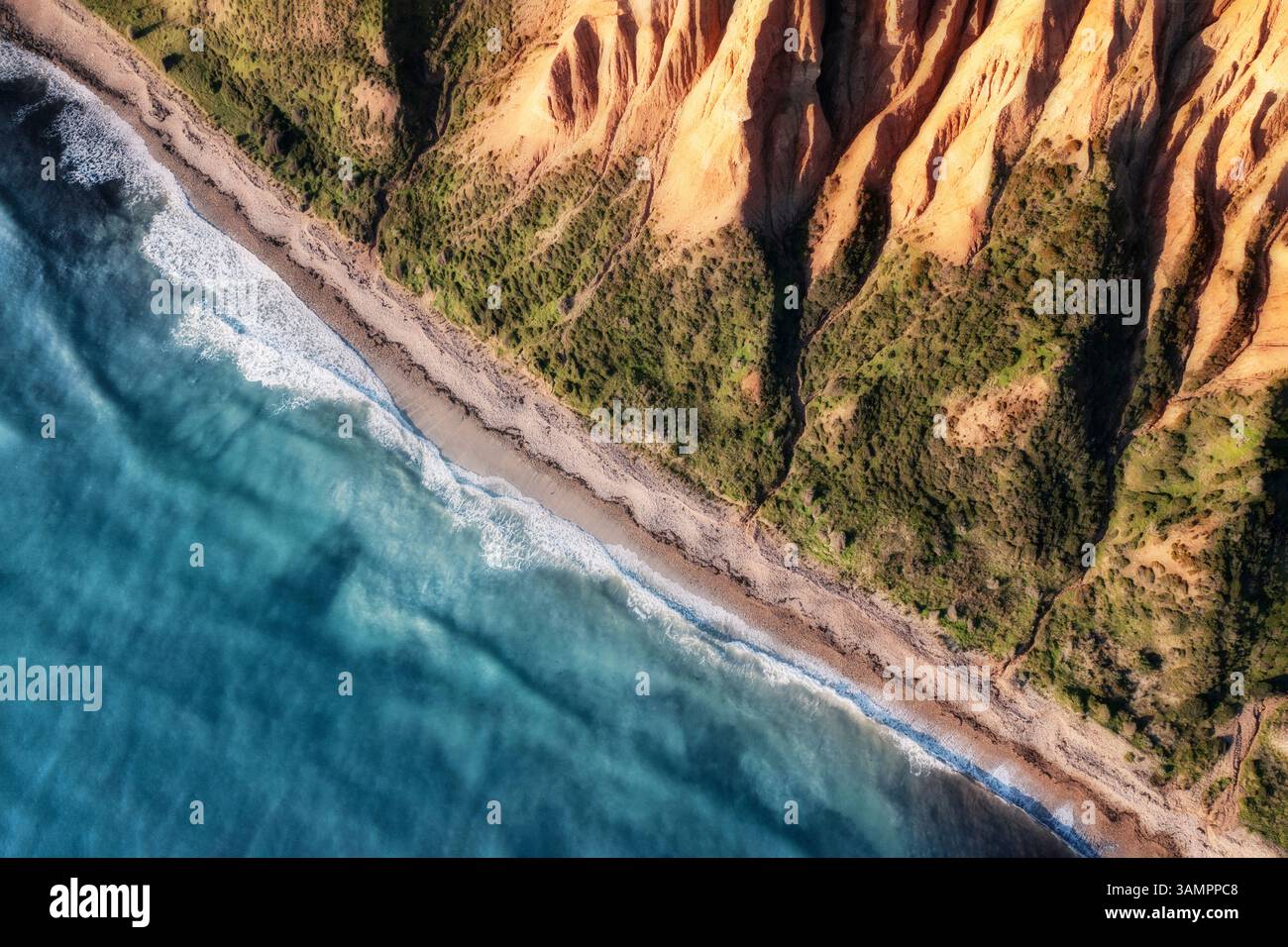 Aerial view of the rugged Sellicks Beach cliffs with blue ocean waves ...