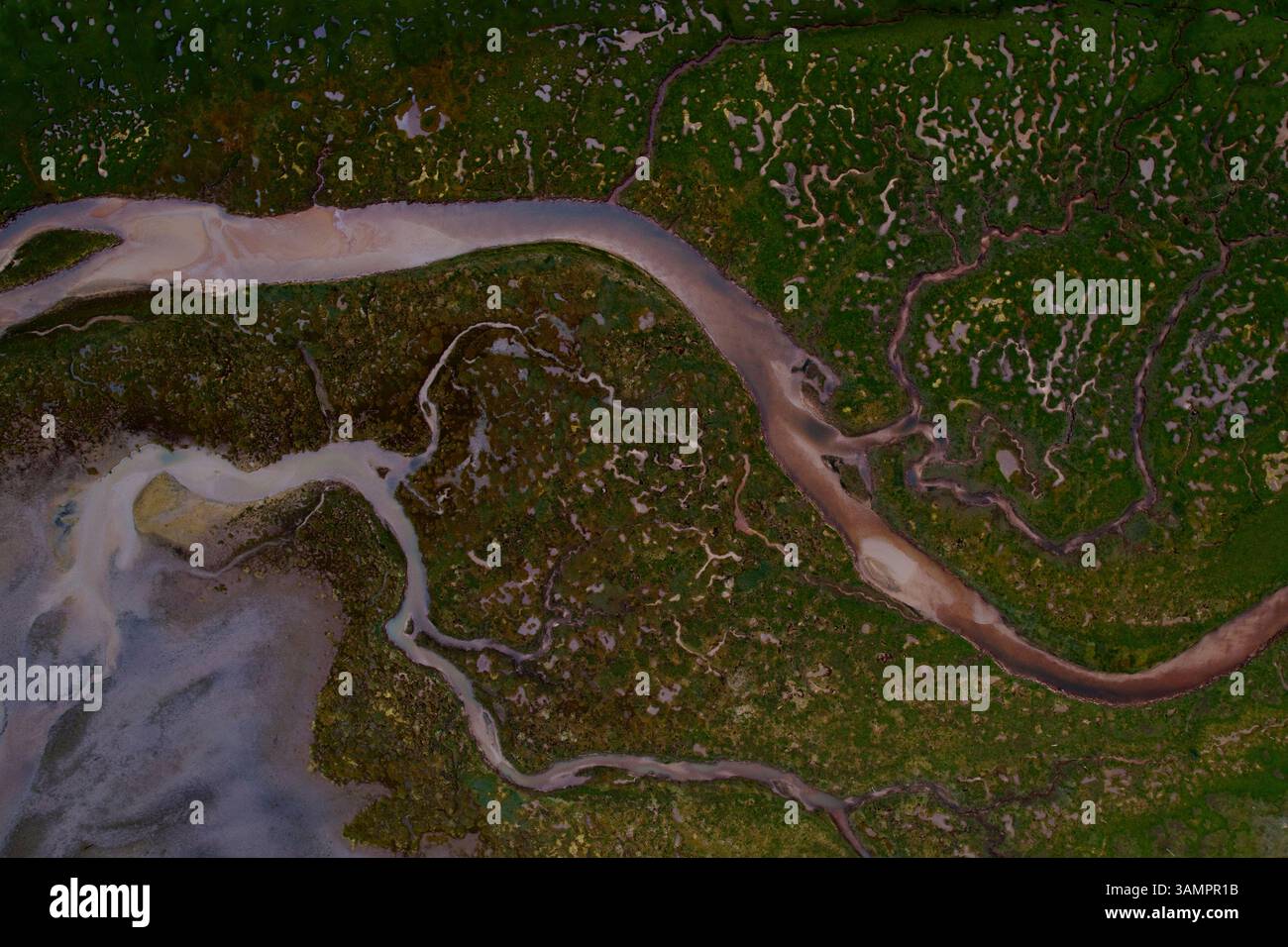 Aerial view of abstract tidal patterns and meandering river in a ...
