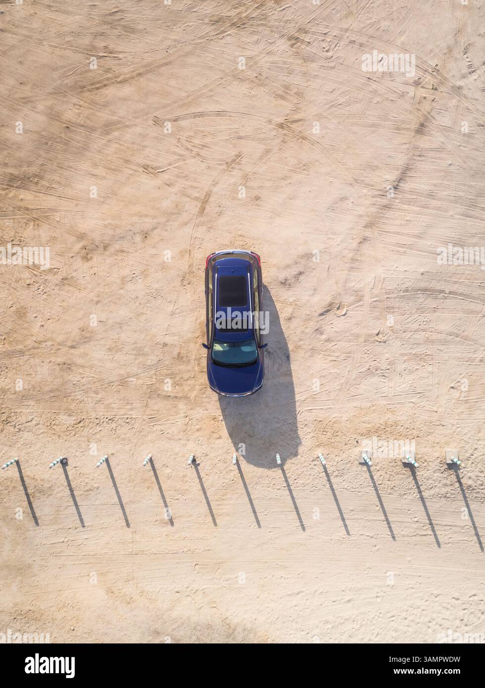 Aerial view of a car parked on the sandy Jabal Ali beach in Dubai, U.A ...