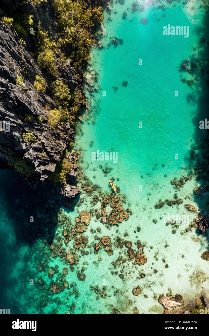 Aerial view of people with a kayak sailing across El Nido Bay, Palawan ...