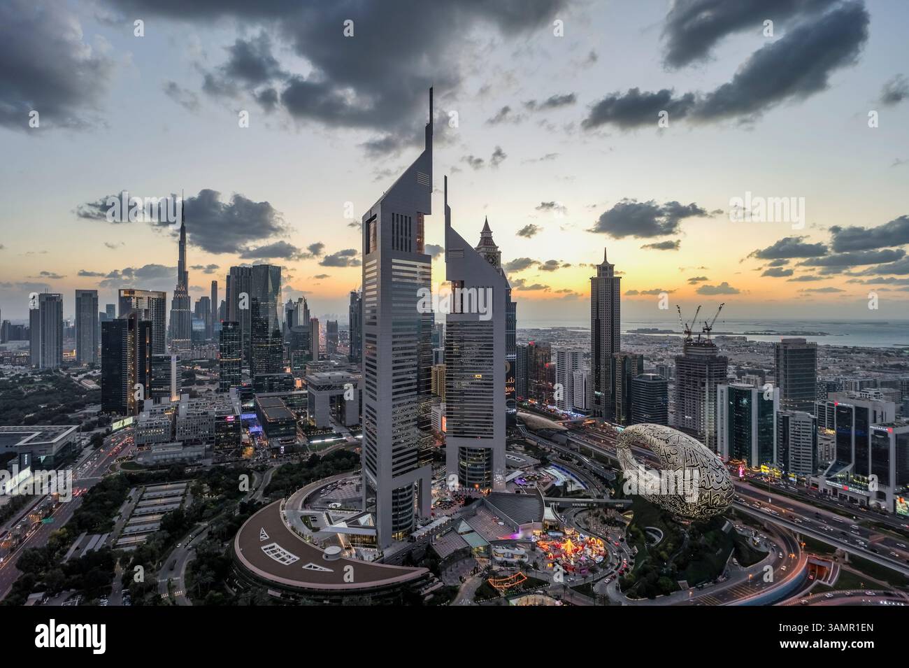Aerial view of futuristic Dubai skyline at sunset, Emirates Towers ...