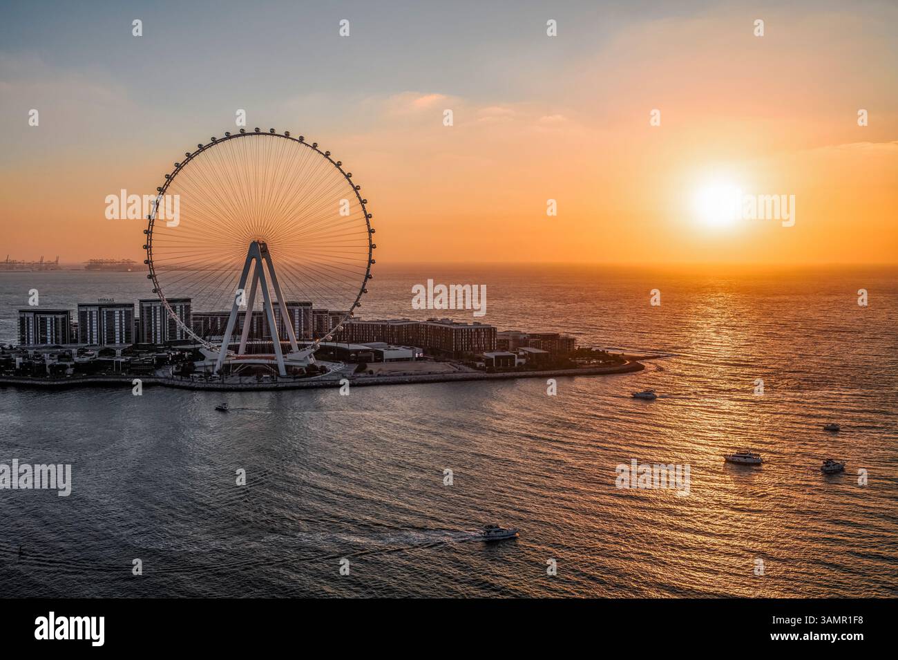 Aerial view of Dubai Marina with Ain Dubai Ferris wheel at sunset ...
