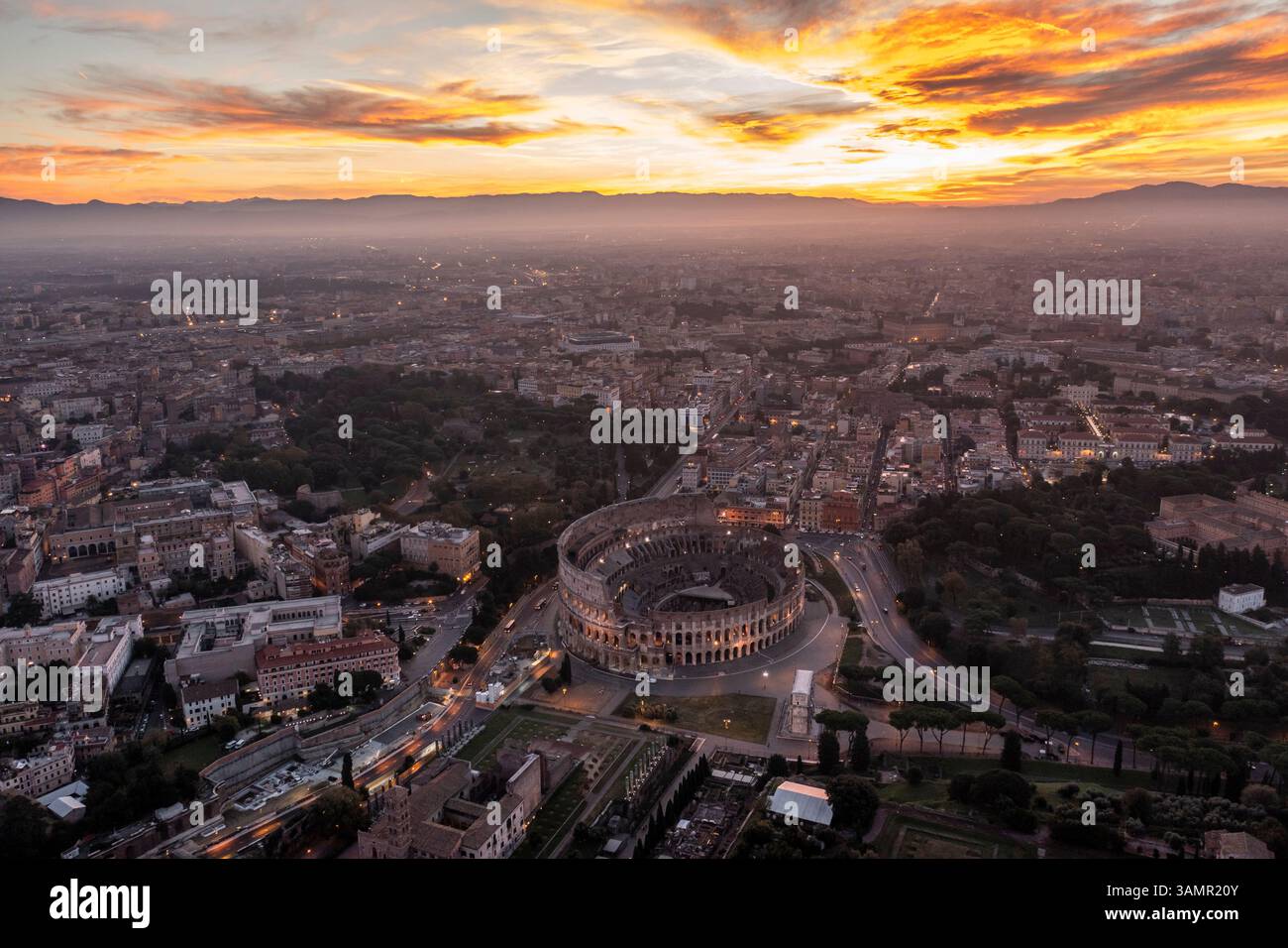 Aerial view of the Colosseum amphitheater in Rome downtown at night ...