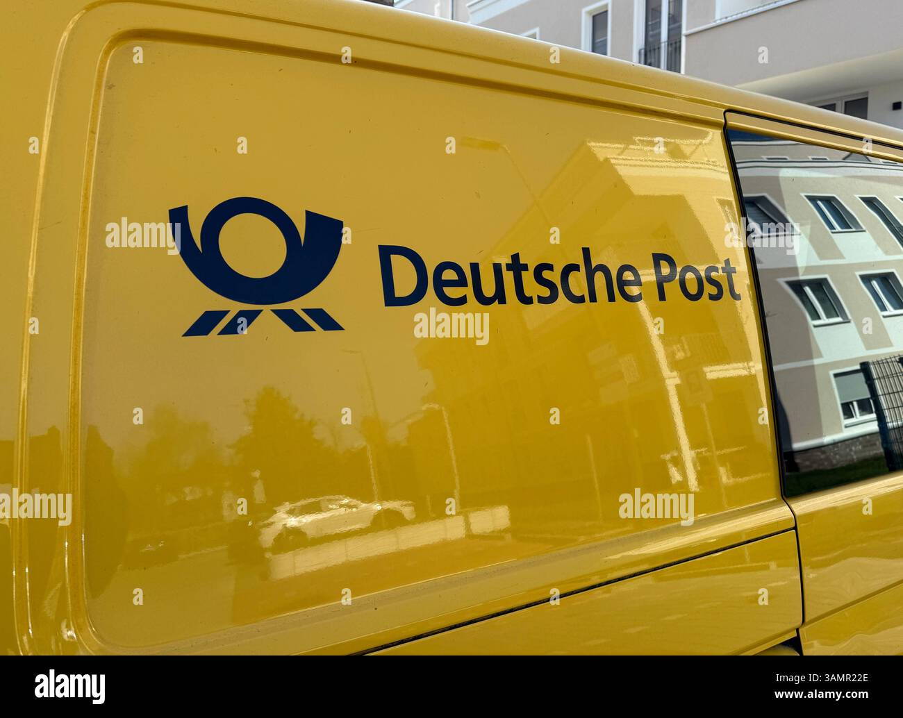 Logo Deutsche Post DHL an einem Postauto *** Deutsche Post DHL logo on ...