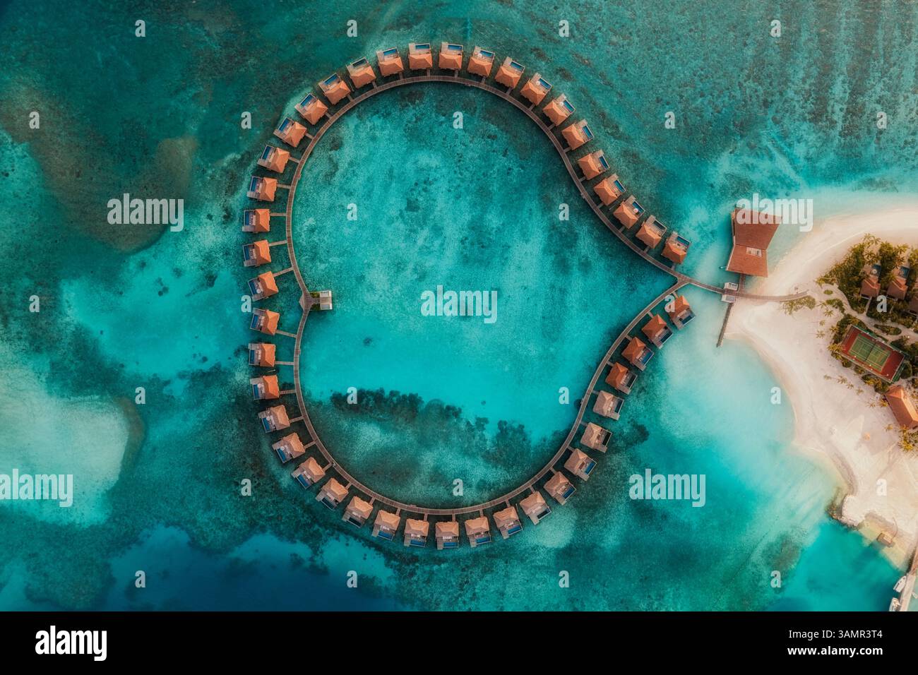 Aerial view of a beautiful luxury resort at sunset on Alifu Dhaalu ...