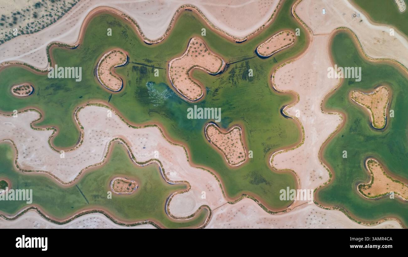 Aerial view of Al qudra lakes in the middle of the Saih Al Salam Desert ...