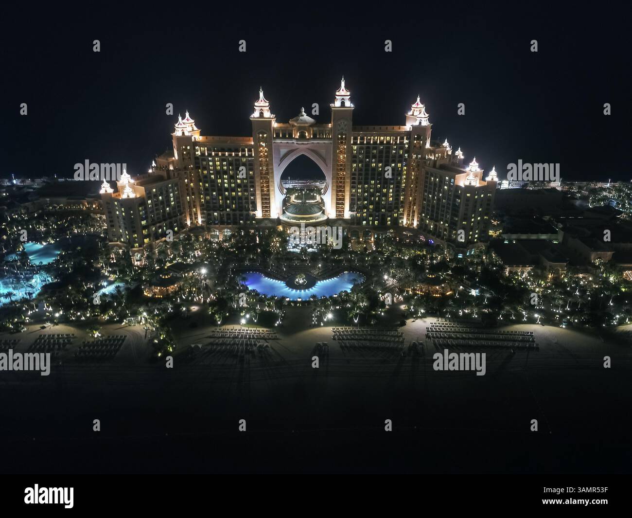 Aerial view of the luxurious Palm Jumeirah Atlantis Hotel at night in ...