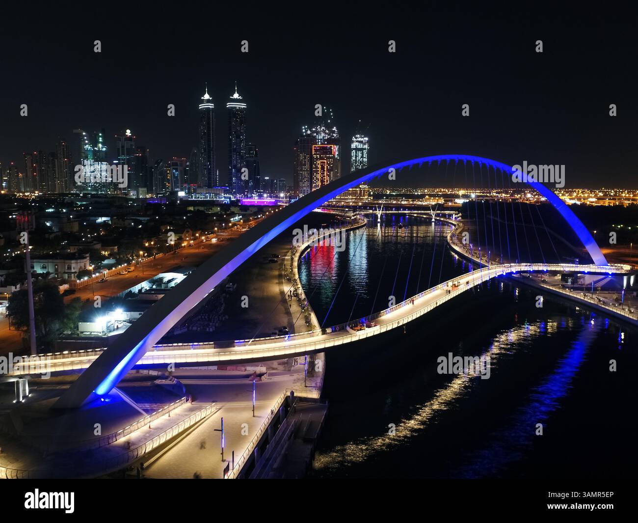 Aerial view of the Tolerance pedestrian Bridge in Dubai at night in ...