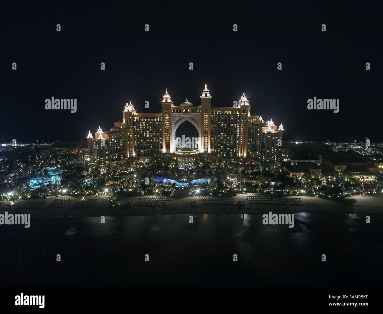 Aerial view of the luxurious Palm Jumeirah Atlantis Hotel at night in ...