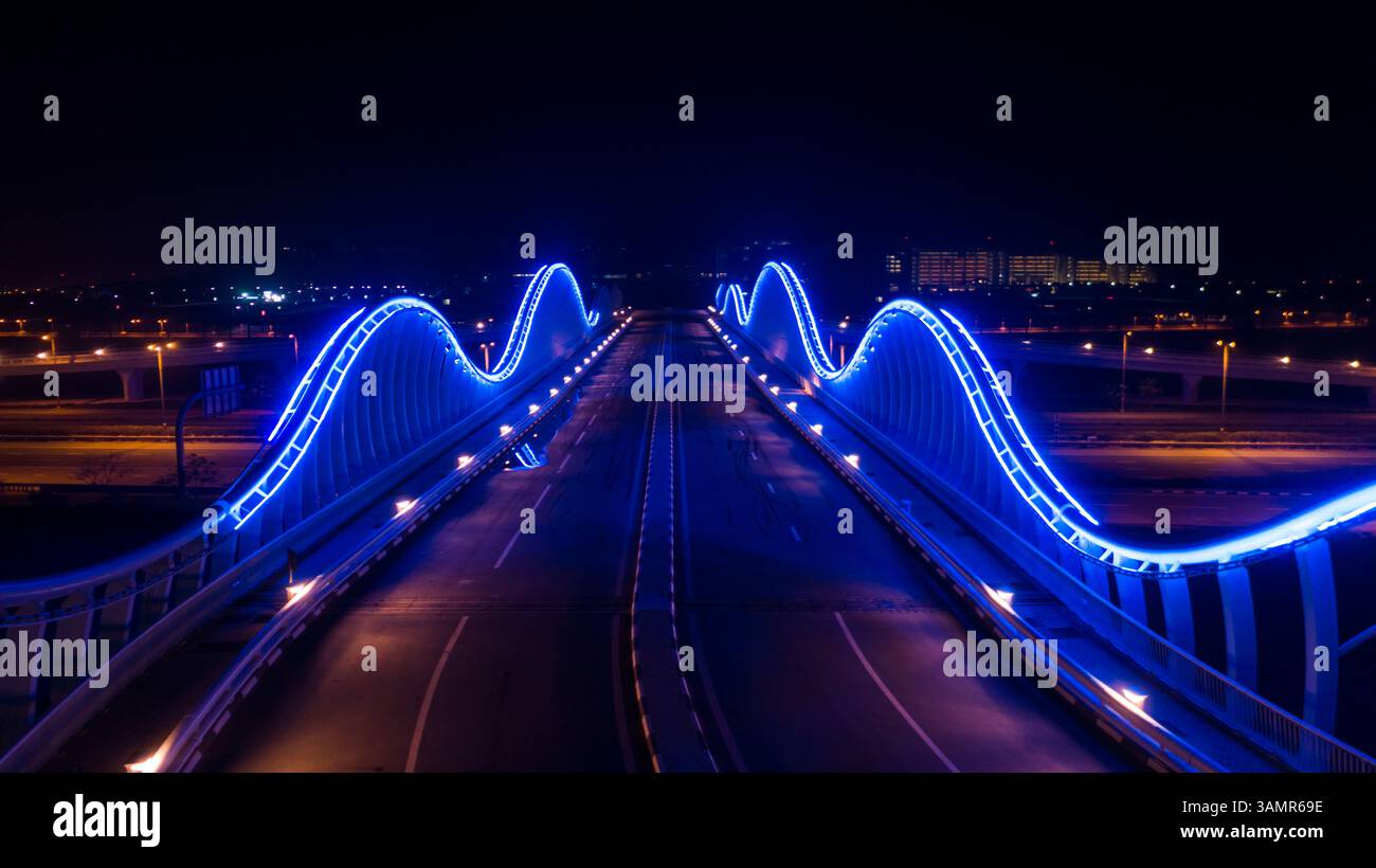 Aerial view of the illuminated Meydan bridge at night in Dubai, United ...