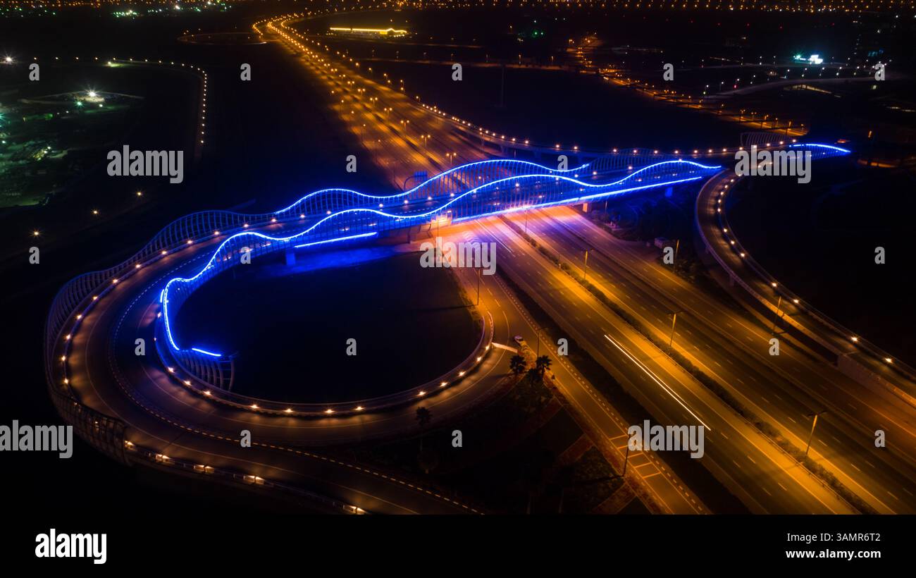 Aerial view of the illuminated Meydan bridge at night in Dubai, United ...