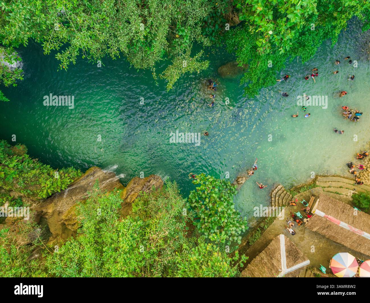 Aerial view of people swimming in pool by Kawasan Falls in Alegria ...