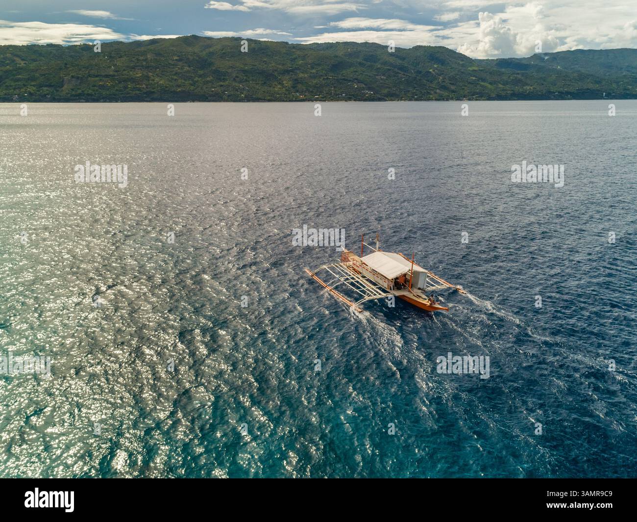 Aerial view of traditional filipino fishing boat by Sumilon island ...
